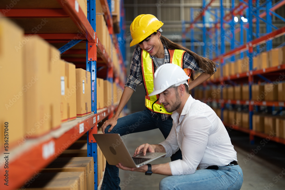 Supervisor and manager smiling happy holding laptop computer on hand ...