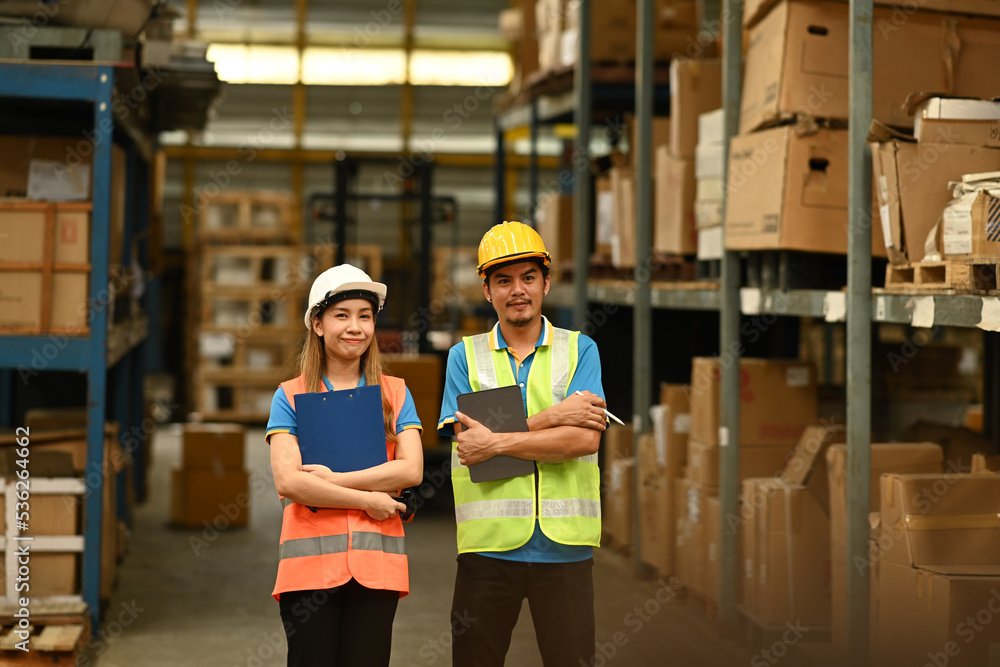 Image of warehouse workers wearing hardhats and reflective jackets ...
