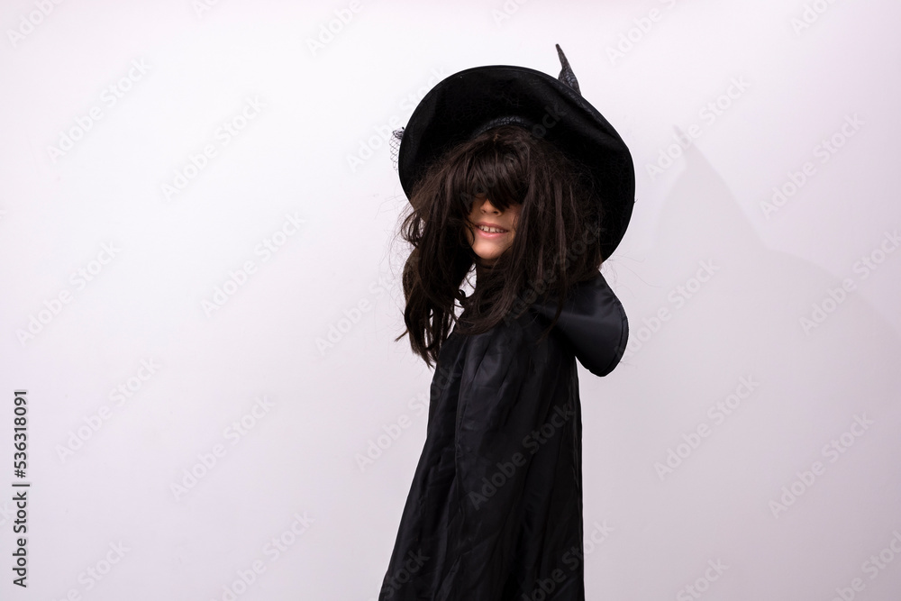 serious Halloween kid on white background covering his face with his ...