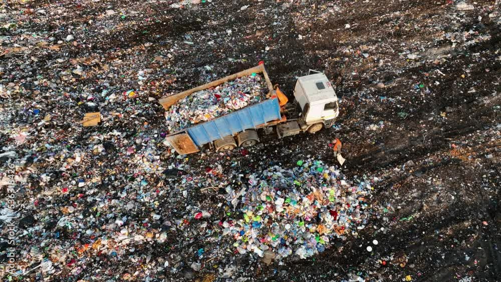 Garbage truck unloads rubbish. Landfill with solid household waste ...