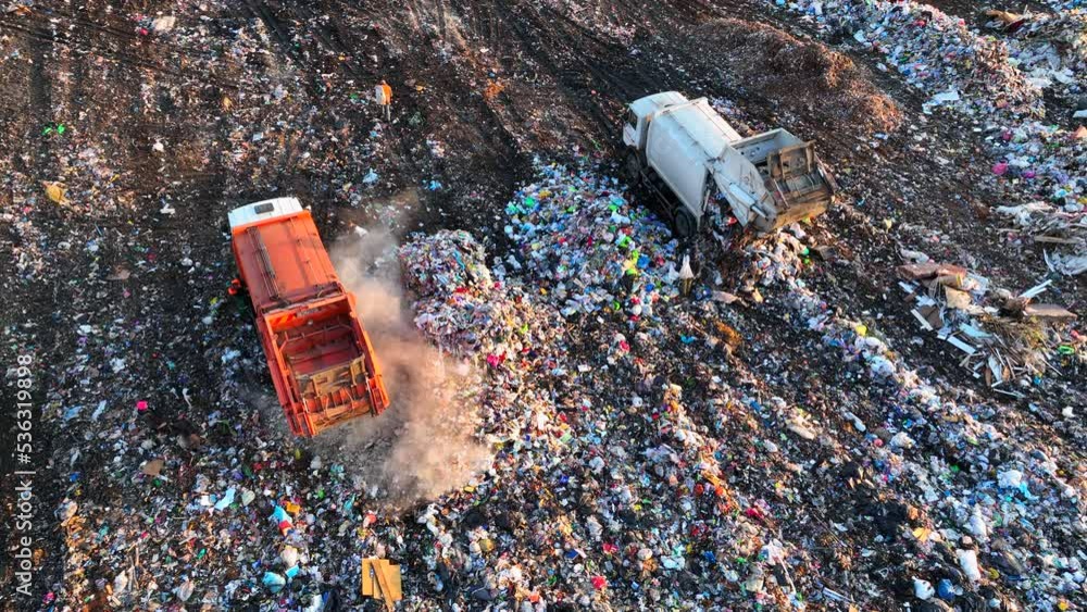 Garbage truck unloads rubbish. Landfill with solid household waste ...