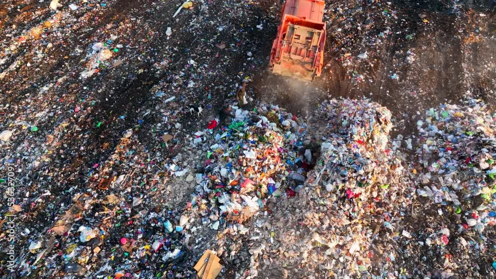Garbage truck unloads rubbish. Landfill with solid household waste ...