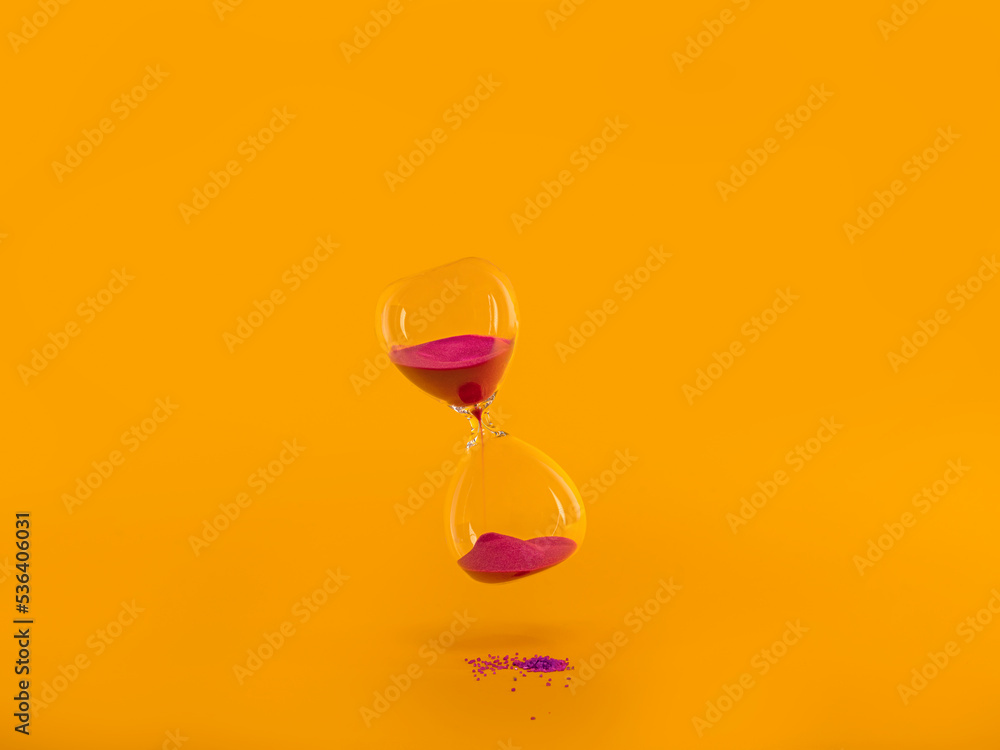 Waste of time concept with an hourglass and sand on a table Stock Photo ...