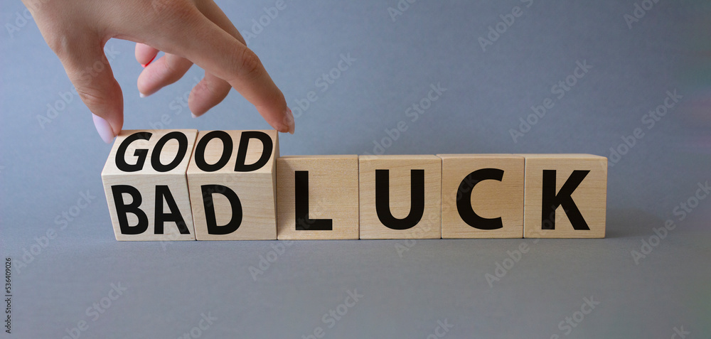 Good Luck and bad Luck symbol. Hand turns a cube and changes the words ...