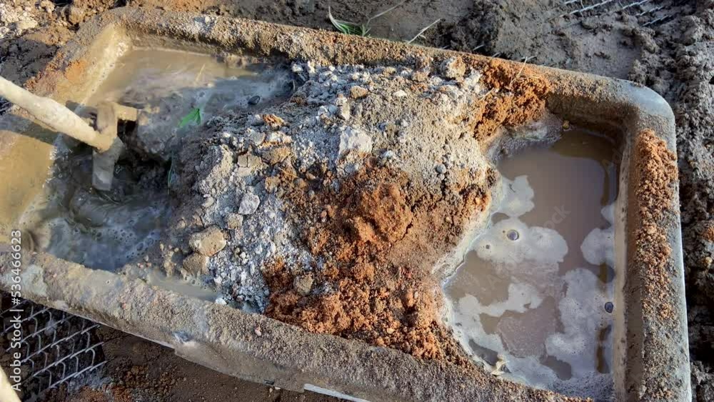 Mixing mortar with a mixer. Cement mortar mix. Mortar consists of a mix ...