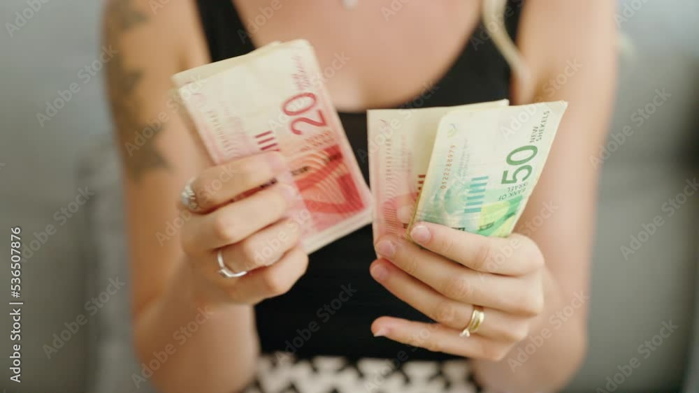 Young woman counting israel shekel banknotes at home Stock Video ...