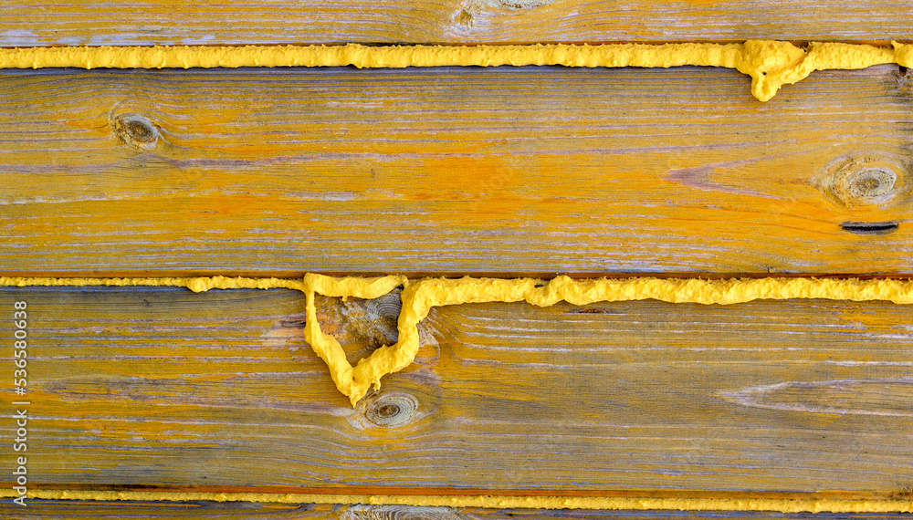 sprayed and hardened polyurethane foam from a cylinder on the wall of ...