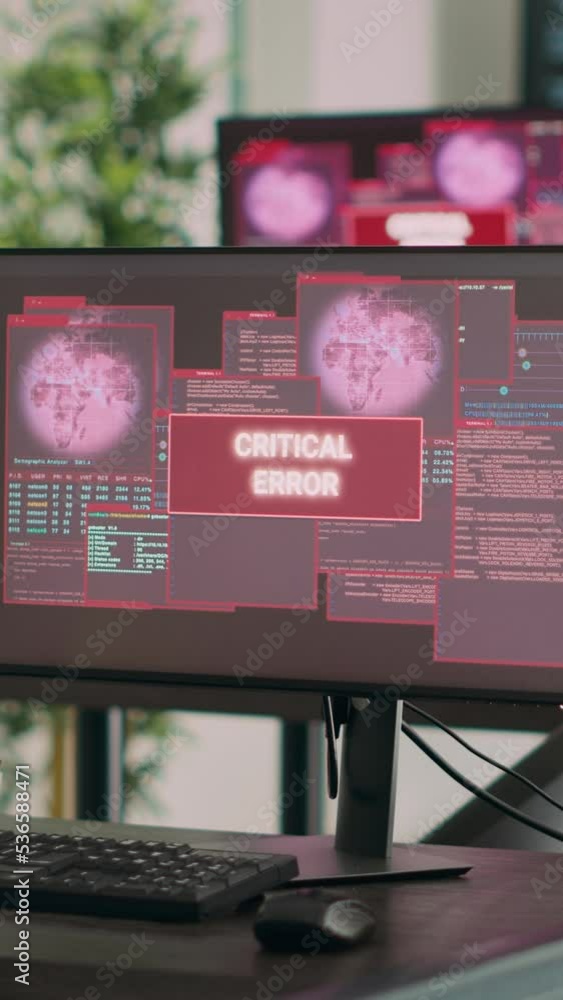 Vertical video: Empty it office desk with multiple computers showing security breach warning on ...