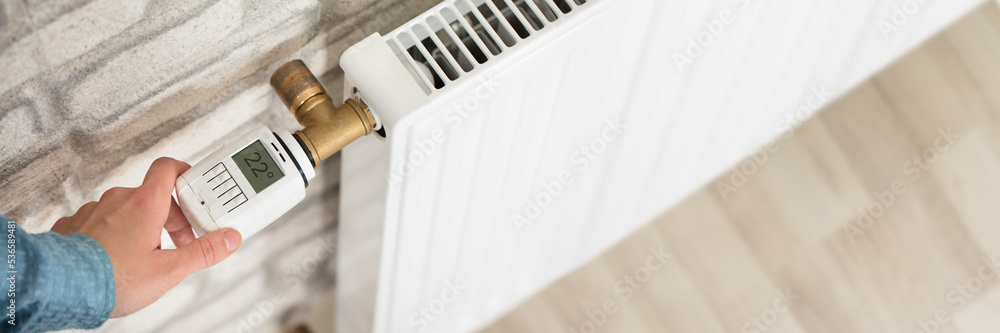 Person Adjusting Temperature On Thermostat Stock Photo | Adobe Stock