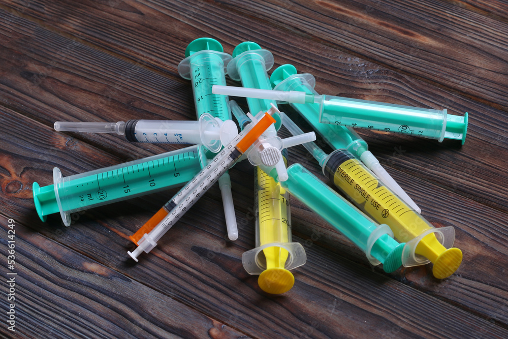 Top view of a pile of syringes and insulin syringes ready for injection ...