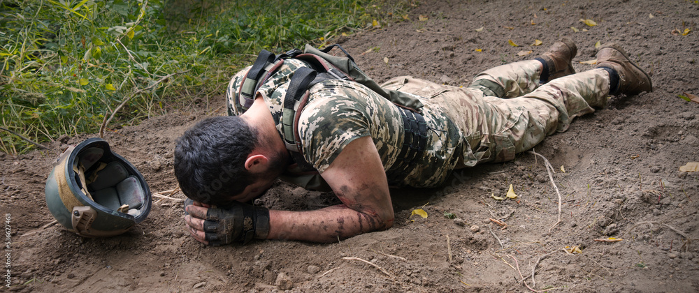 Sad soldier laying on the ground Stock Photo | Adobe Stock