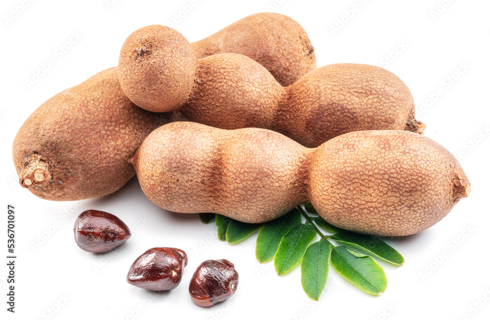 Ripe tamarind fruit, leaves and some tamarind seeds isolated on white ...