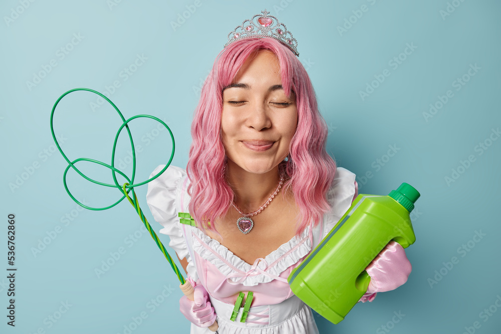 Pleased maid with long pink hair keeps eyes closed happy to finish ...