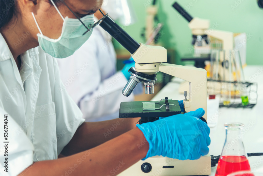 Indian Scientist man look into Microscope research in science ...