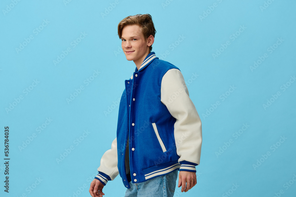 beautiful, happy an attractive young man student in a trendy bomber ...