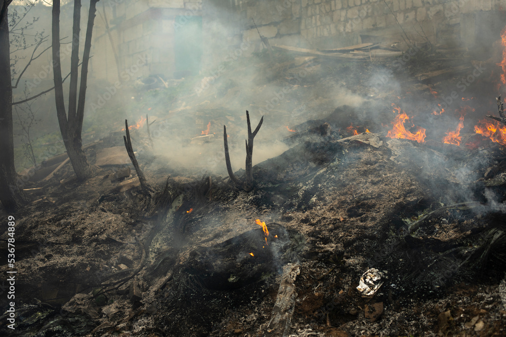 Burning of garbage. Set fire to illegal landfill. Flames and smoke ...