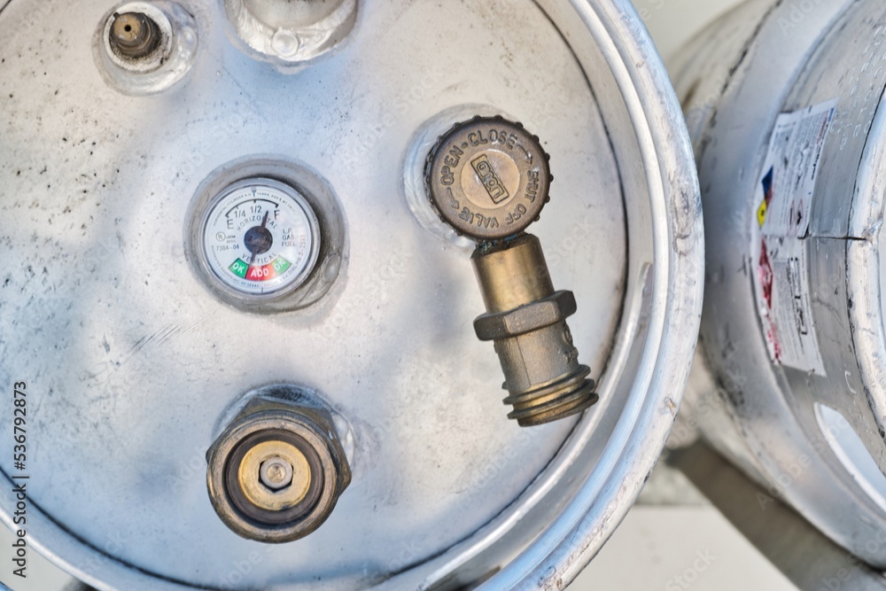 Liquid Petroleum gas cylinders top closeup with propane level gauge and ...