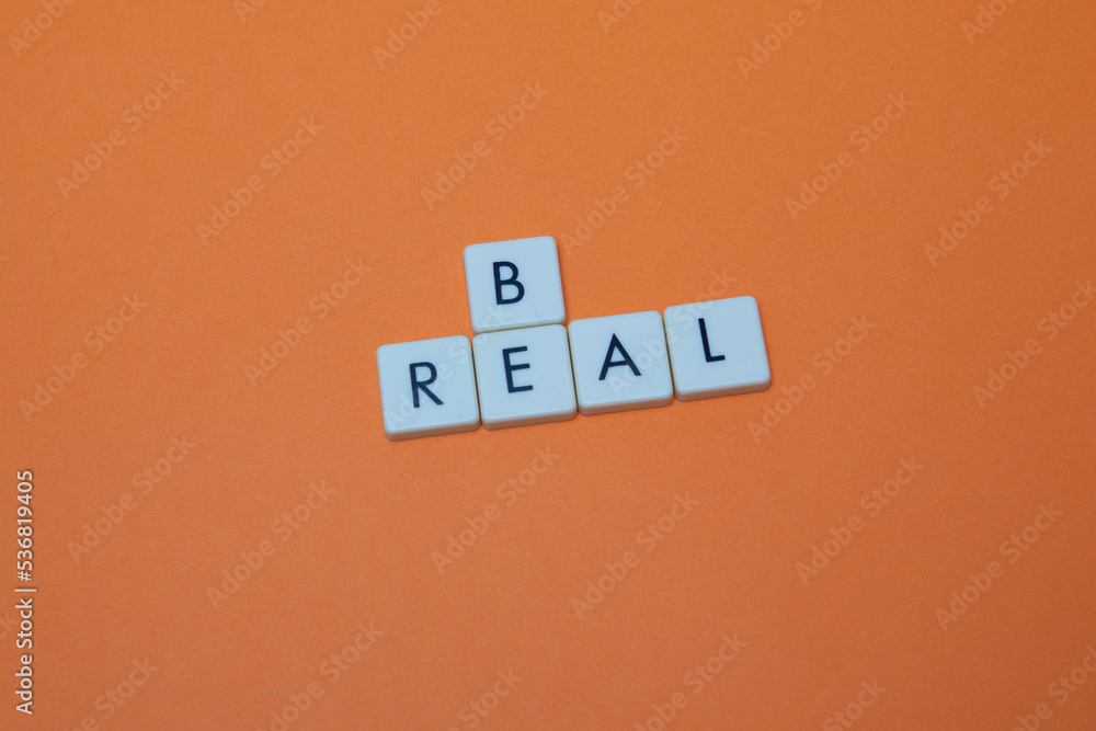 Be real text with plastic letters on orange paper sheet. Popular and ...