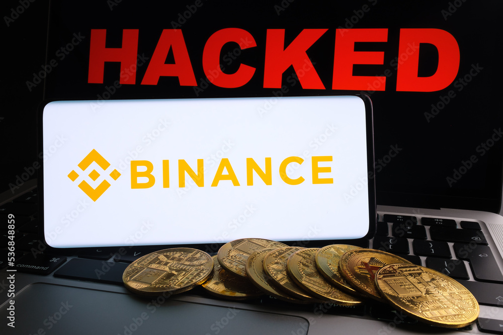 Binance crypto exchange hacked. Binance logo seen on smartphne and red ...