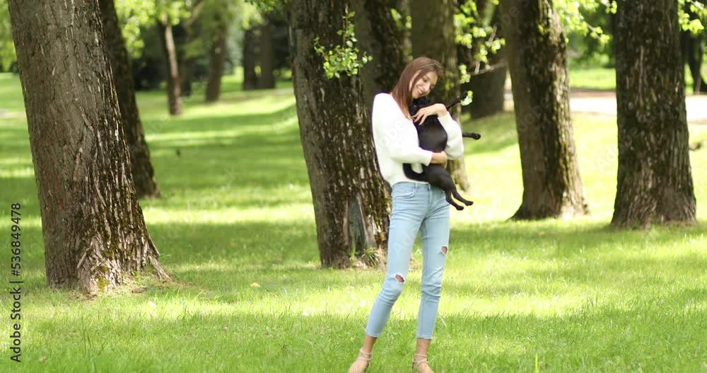 Vídeo do Stock: white woman plays with pet black cute pet pug-dog of ...