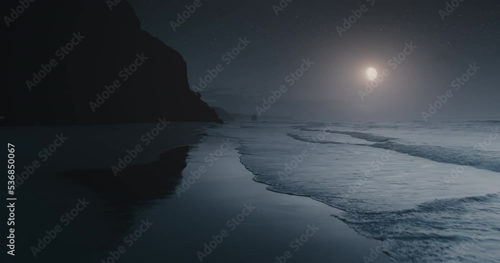 Moonlight ocean waves wash sand beach. Aerial moon glow and starry sky ...
