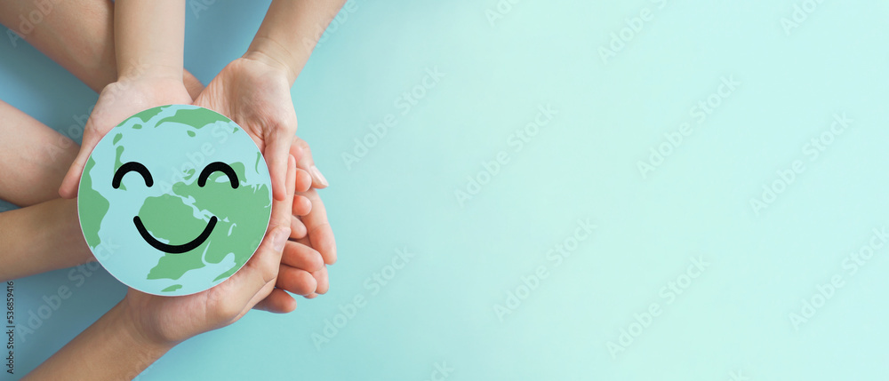 Hands holding earth with smile face, save planet, earth day ...