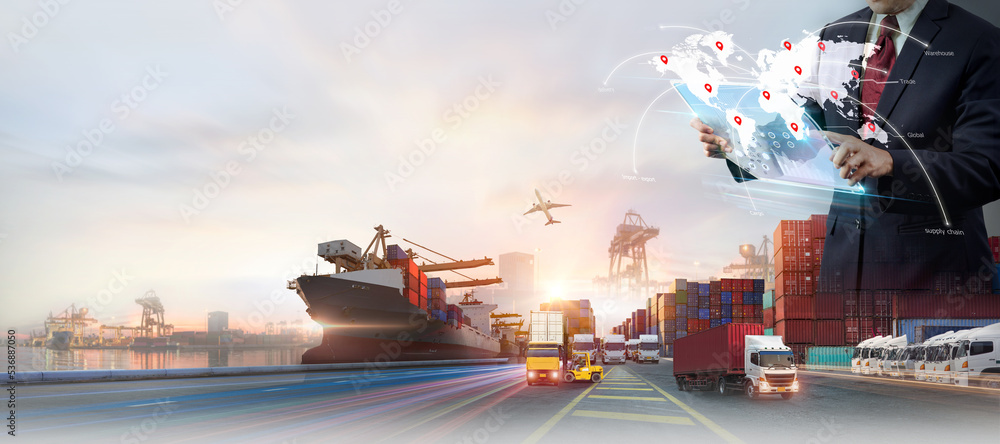 Businessman holding virtual interface panel of global logistics network ...
