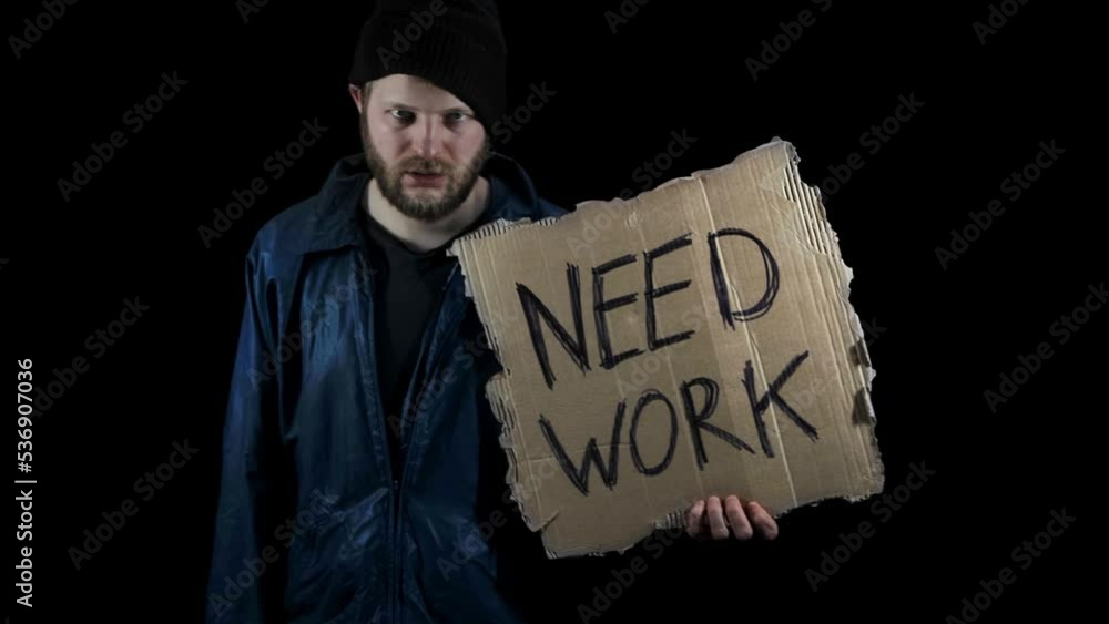 Homeless holds piece of cardboard with inscription Need Work. Male ...
