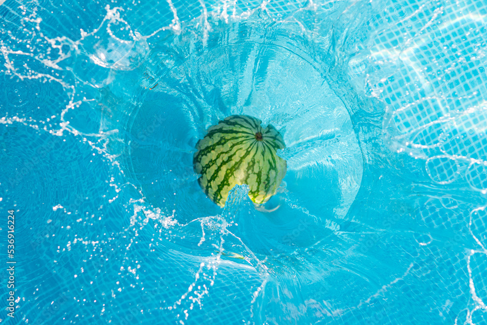 Watermelon falling into swimming pool Stock Photo | Adobe Stock
