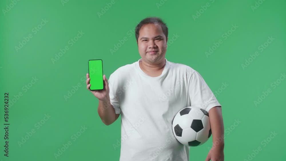 Asian Man With A Ball Showing Mock Up Green Screen Smartphone And ...