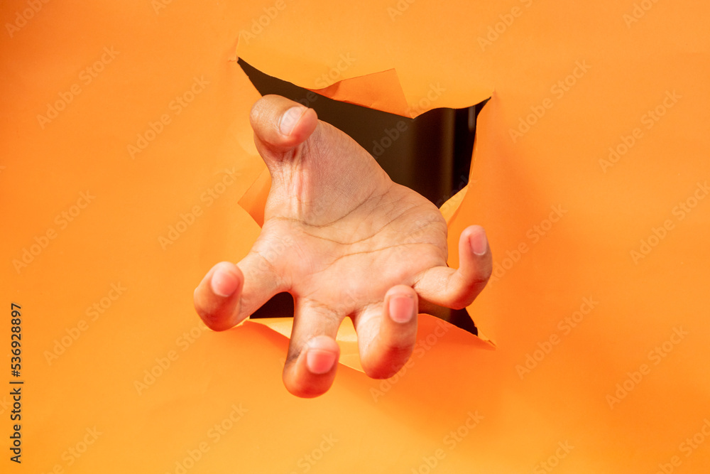 hand gesture on torn orange paper background Stock Photo | Adobe Stock