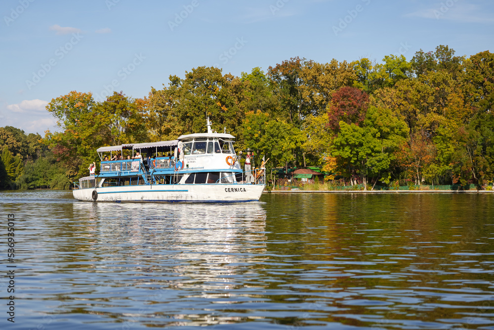 Boat cruise on Herastrau Lake from Bucharest. People on a boat cruising ...