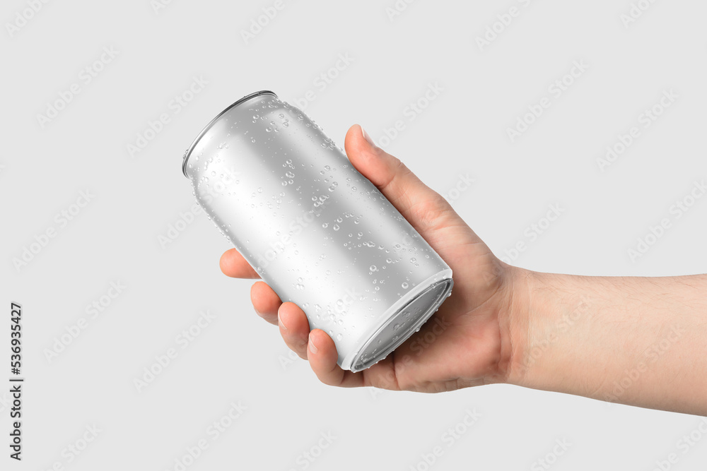 Aluminium drink can 330ml with water drops in a hand mockup template ...