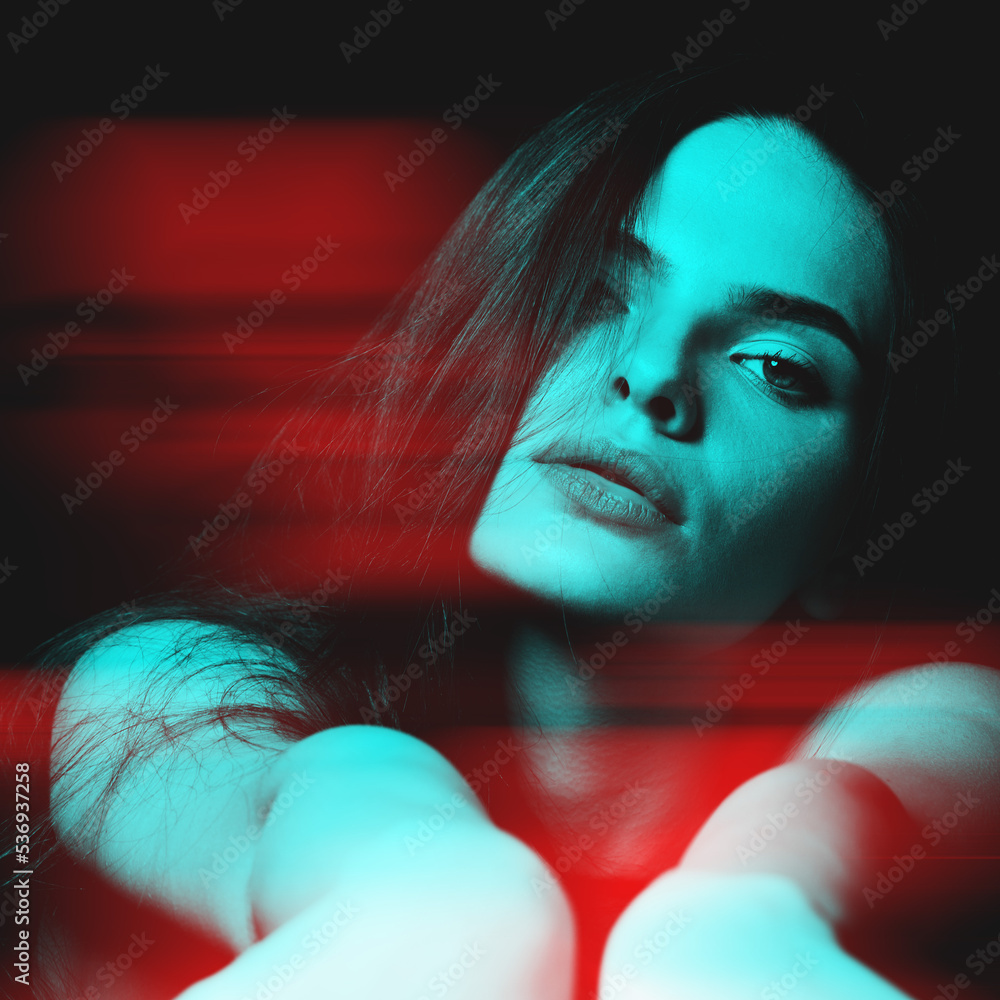 Studio portrait of beautiful woman with long dark hair looking to ...