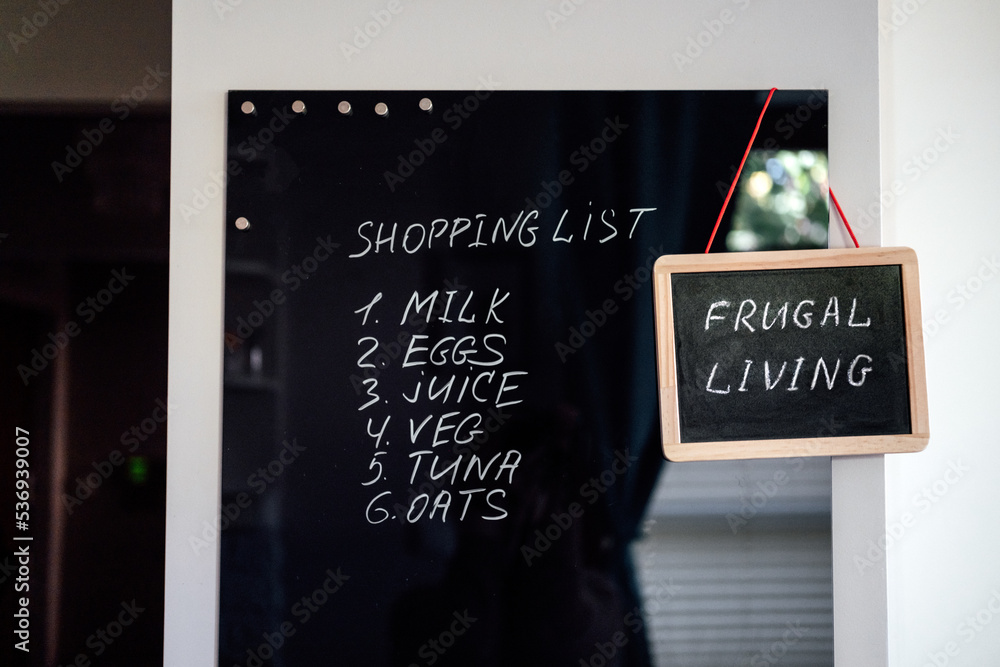 Frugal living, save money, live cheap concept with shopping list on ...
