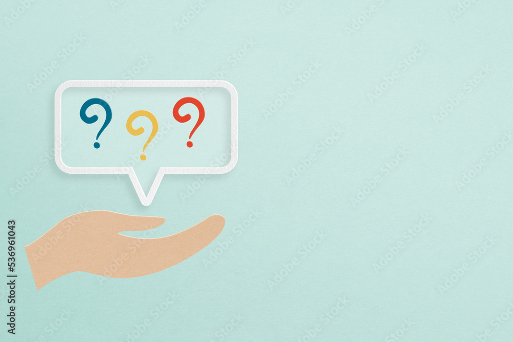 multi color question marks inside speech bubble paper cut over hand ...