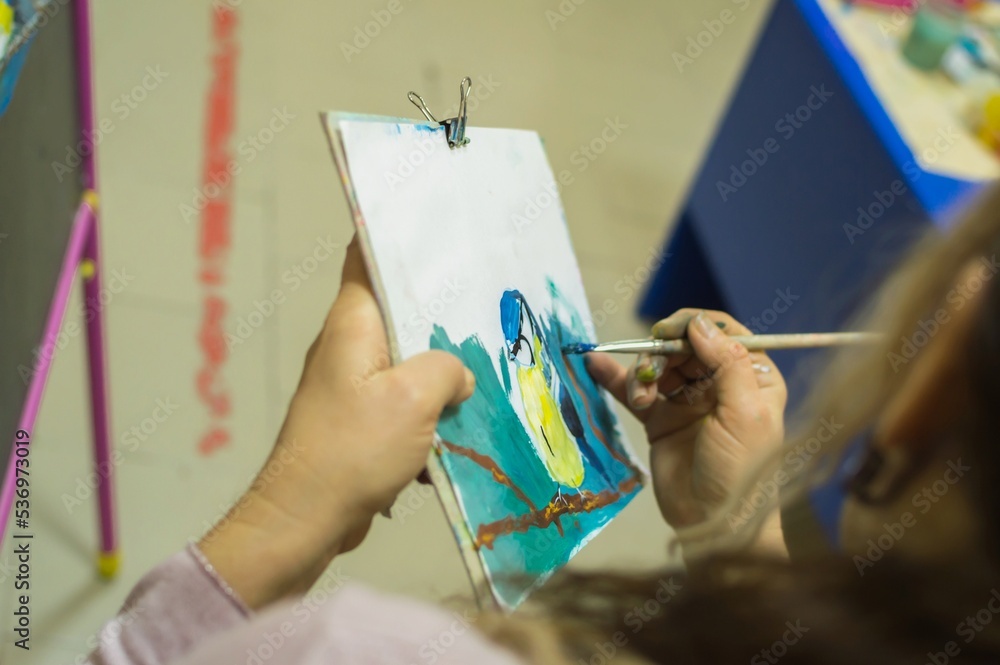 Drawing lesson. Teacher shows how to draw with gouache Stock Photo ...