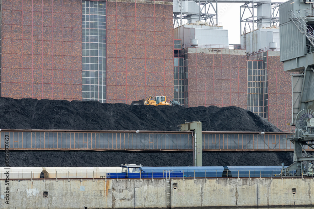 Coal mountain with bucket wheel excavator and train in coal power plant ...