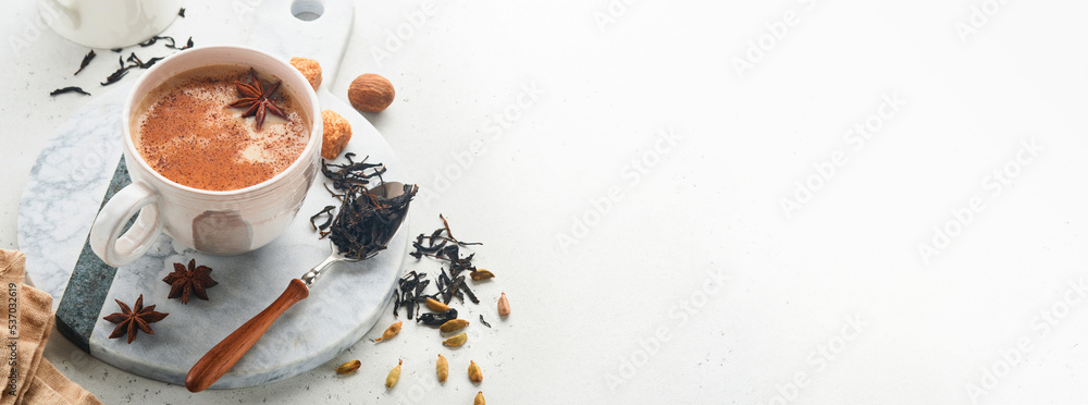 Masala tea. Masala chai spiced tea with milk and spices on light grey ...