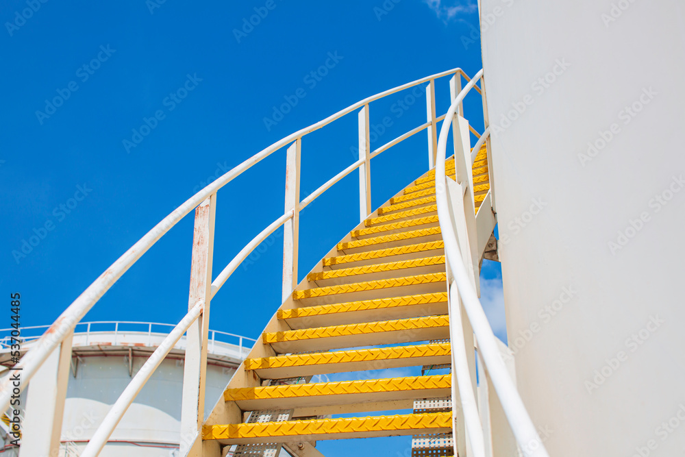 Large Industrial tanks for oil with a walkway up and down of oil ...