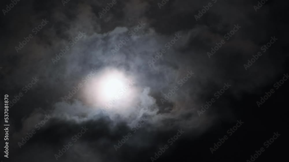 Full moon in the night sky moves through dark clouds, Timelapse. The ...