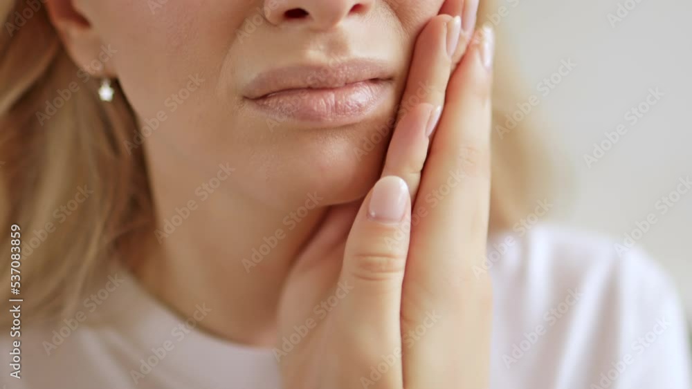 Woman with a toothache, touching her face. The concept of dental ...