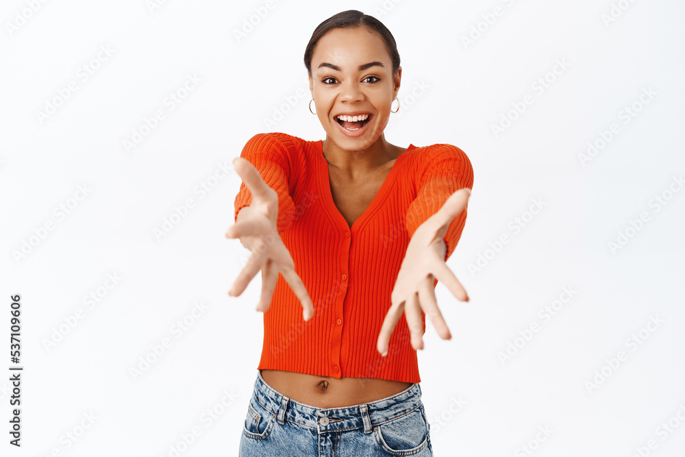 Portrait of excited young woman, reaching hands forward, stretching out ...