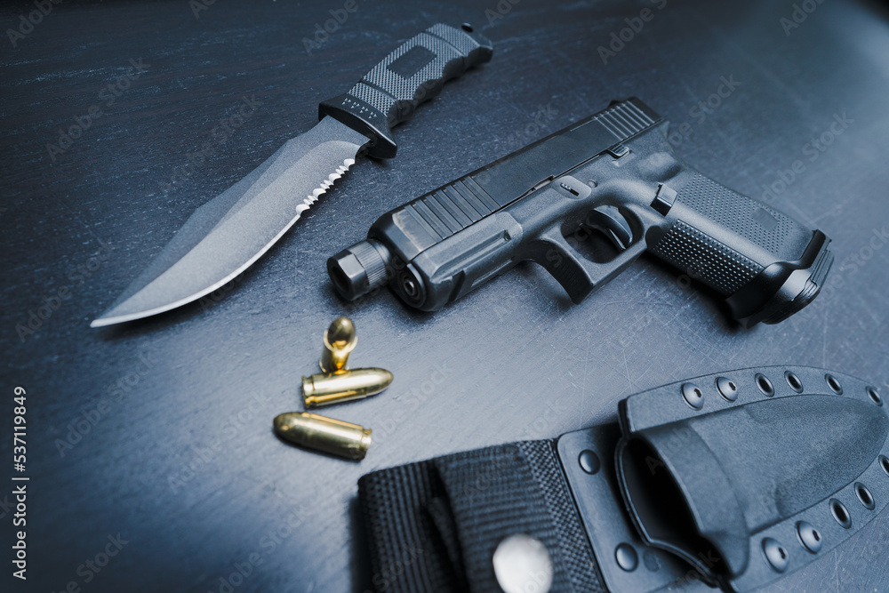 Large knife and gun, close-up photo. Stock Photo | Adobe Stock