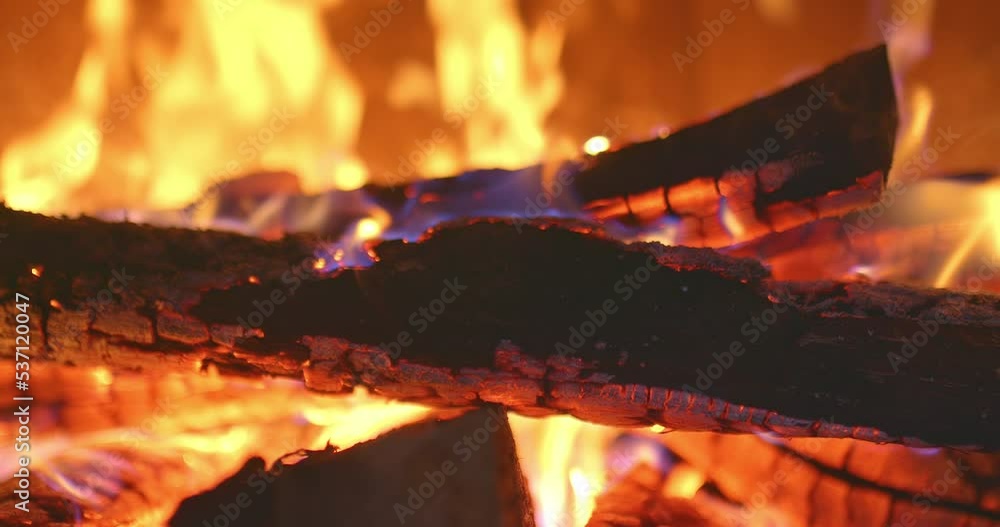 Close-up, charred logs on fire. Flame of fire, cozy house, fireplace ...