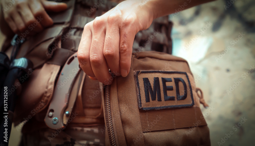A soldier, a tactical medic opens a first aid kit, close-up view. Stock ...
