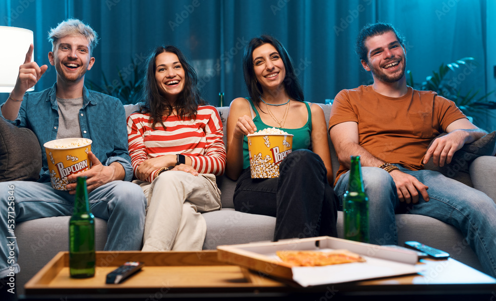 Happy friends watching movies together Stock Photo | Adobe Stock