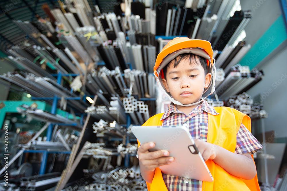 Asian boy dressed as a craftsman and holding tools Stock Photo | Adobe ...