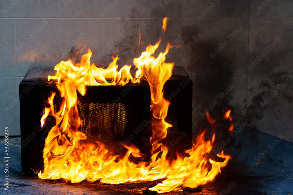 microwave oven on fire. the concept of fire in the kitchen and ...