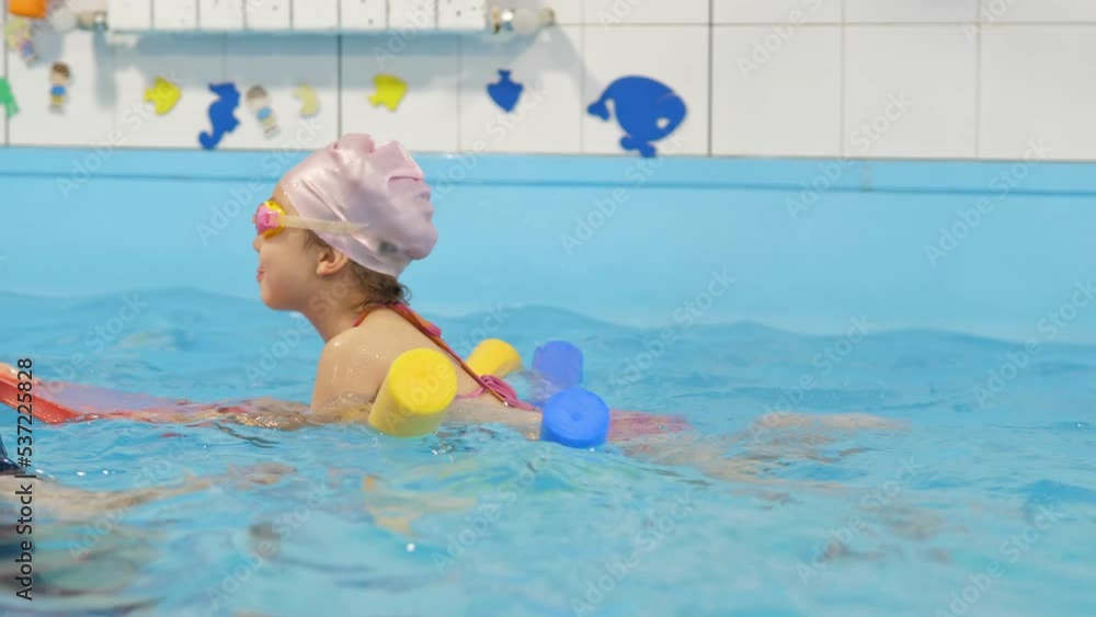 Individual swimming lesson with a male personal trainer in an indoor ...